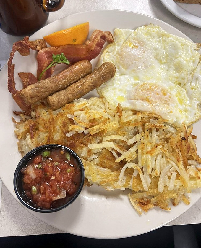 Breakfast nirvana achieved: perfectly sunny-side-up eggs, crispy bacon, sausage links, and hash browns that deserve their own fan club.