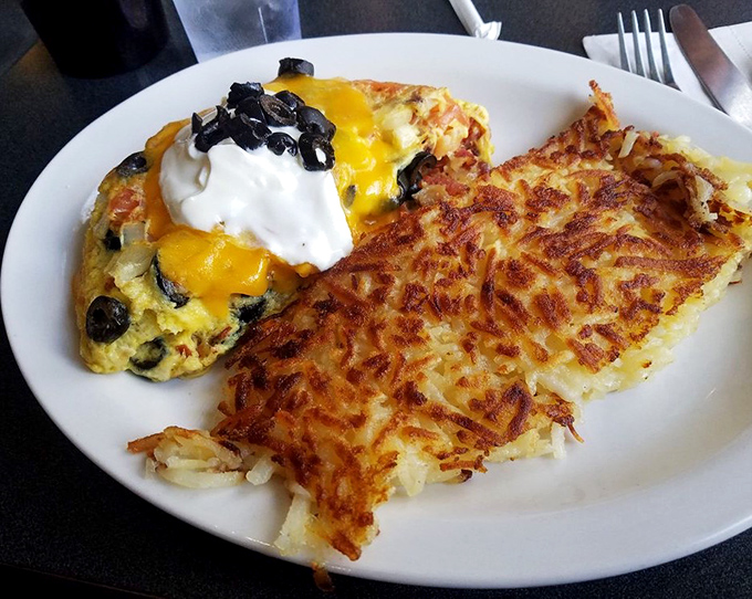 Hash browns with the golden-crisp exterior that dreams are made of, paired with an omelet that's practically floating with fluffiness. Breakfast nirvana achieved.