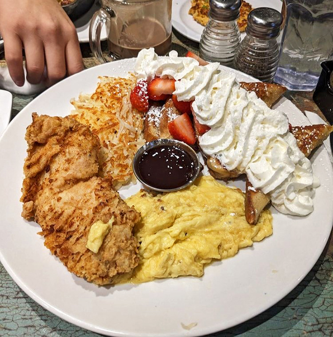 Breakfast indecision solved! Crispy fried chicken, fluffy scrambled eggs, and French toast with whipped cream create the holy trinity of morning satisfaction.