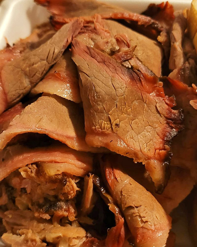 Brisket so tender it practically surrenders to your fork. That pink smoke ring is the BBQ equivalent of a Michelin star.