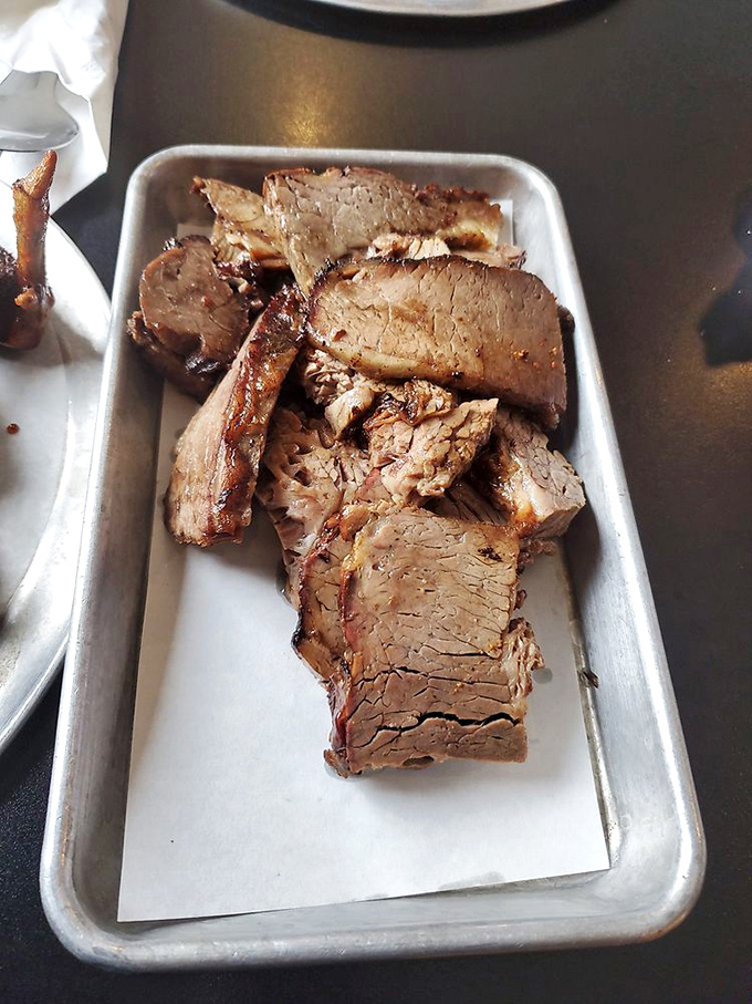 Brisket so perfectly sliced you could frame it. That bark and moisture level would make Texas pitmasters nod in silent, respectful approval.