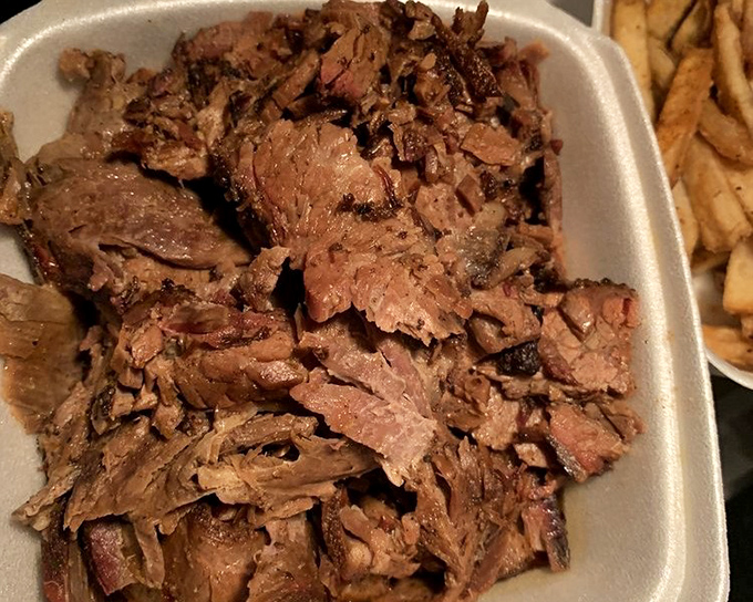 Brisket so tender it practically dissolves on your tongue, with a bark that provides just enough resistance to remind you this is serious barbecue business.