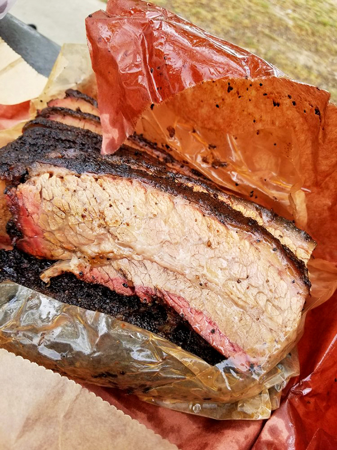 Behold the holy grail of Texas barbecue: Franklin's brisket with its glistening bark and perfect smoke ring. Meat architecture that would make Michelangelo weep.