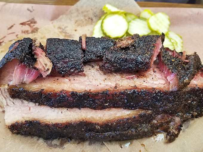 Brisket with that coveted black bark and pink smoke ring&mdash;visual evidence of patience and craftsmanship that no shortcut can replicate.