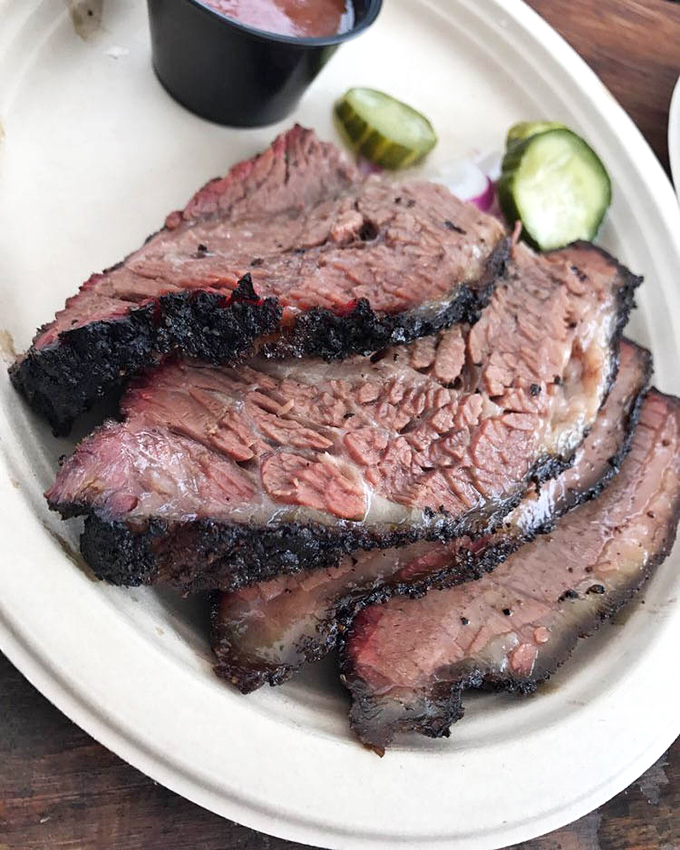 Behold the brisket in all its bark-encrusted glory. That smoke ring isn't just pink—it's practically blushing from all the attention.