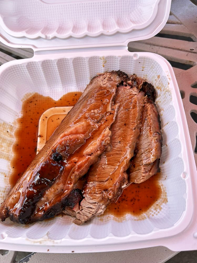 Brisket so tender it practically surrenders to your fork, with that telltale pink smoke ring that's the barbecue equivalent of a Michelin star. 