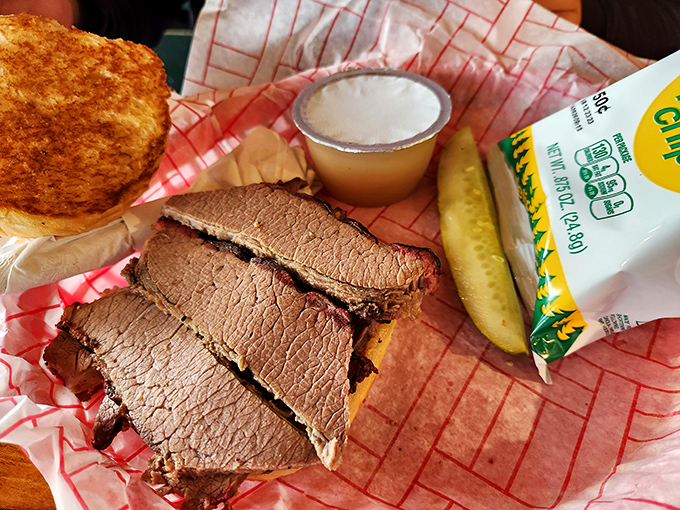 Brisket sliced thick enough to mean business but tender enough to surrender without a fight. That pickle isn't just garnish &ndash; it's necessary balance.