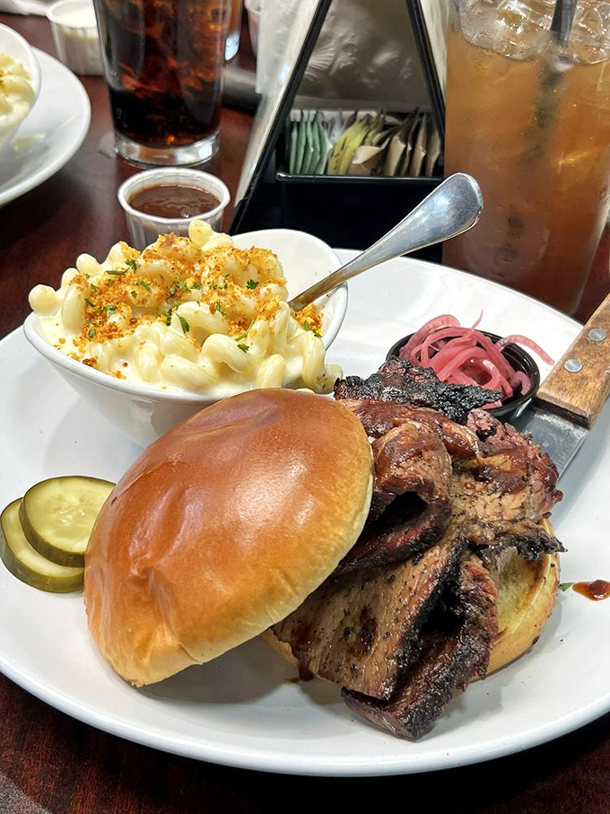 Behold the star of the show! This brisket sandwich with creamy mac and cheese might just be worth driving across state lines for.