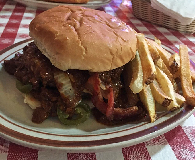 This isn't just a burger; it's a structural engineering marvel that requires both hands, several napkins, and absolutely zero first-date anxiety.