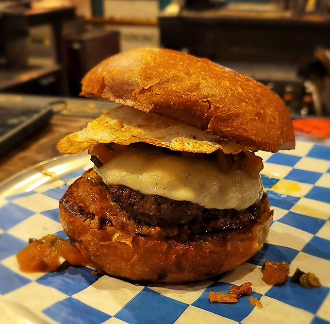 Behold the burger in its natural habitat&mdash;melty cheese cascading over a perfectly seared patty on a golden brioche throne.