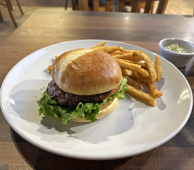 This isn't just a burger; it's a masterpiece of simplicity. Perfectly charred patty, fresh lettuce, and golden fries that snap with each bite.