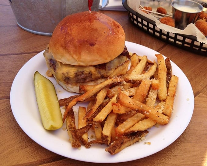 Behold burger perfection &ndash; a golden-brown bun embracing a perfectly charred patty, with crispy, seasoned fries standing guard like delicious sentinels.