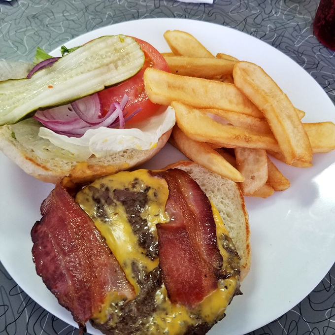 Not all heroes wear capes &ndash; some come stacked with melted cheese, crispy bacon, and fresh veggies alongside golden fries that crunch like autumn leaves.