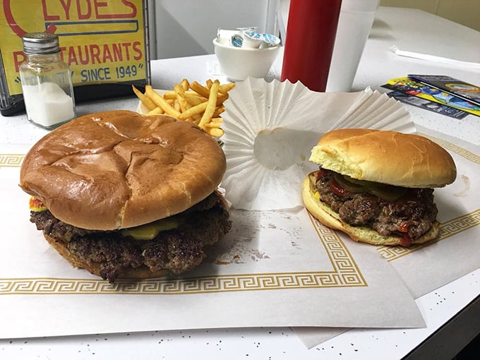 David versus Goliath, burger edition. The regular patty looks on in awe at its big brother, both waiting to fulfill their delicious destiny.