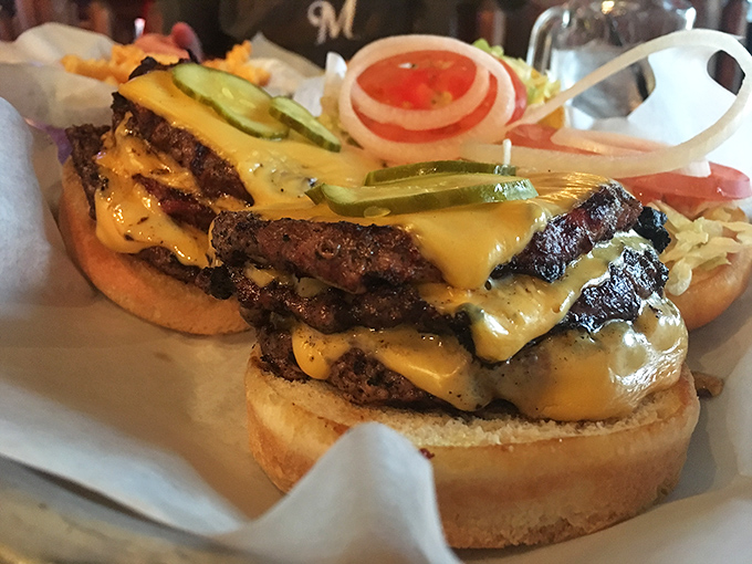 This isn't just a burger; it's a skyscraper of beef with melted cheese cascading down like a yellow waterfall. Architecture you can eat!
