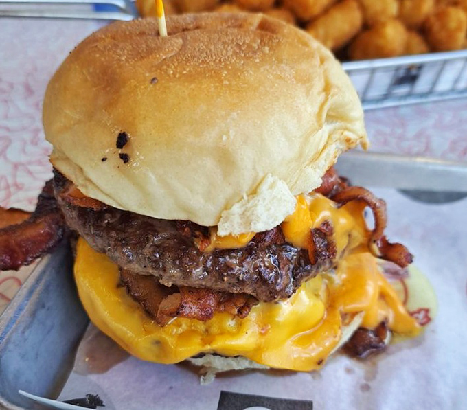 Behold the bacon cheeseburger in its natural habitat—oozing, glistening, and practically begging to be devoured. Diet plans, consider yourselves postponed.