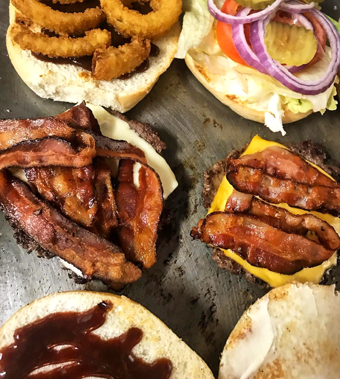 Bacon-loaded burgers that make vegetarians question their life choices. The kind of sandwich that demands both hands and zero shame.