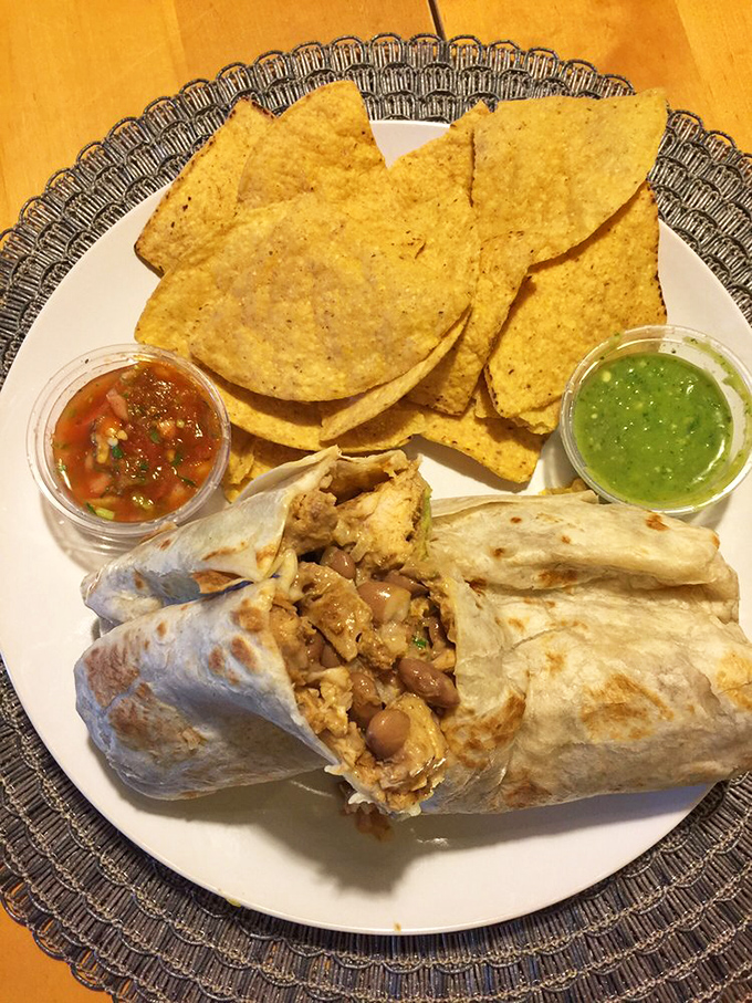 This isn't just a burrito—it's an architectural marvel of perfectly proportioned beans, meat, and cheese that demands to be documented before devouring.