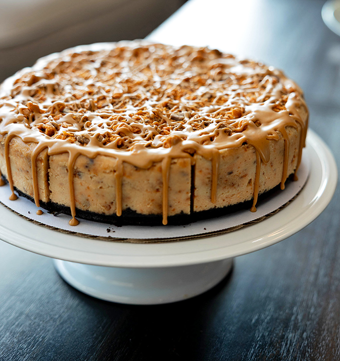 This isn't just dessert, it's architecture – layers of caramel and crunch atop a canvas of creamy perfection that would make Michelangelo weep.