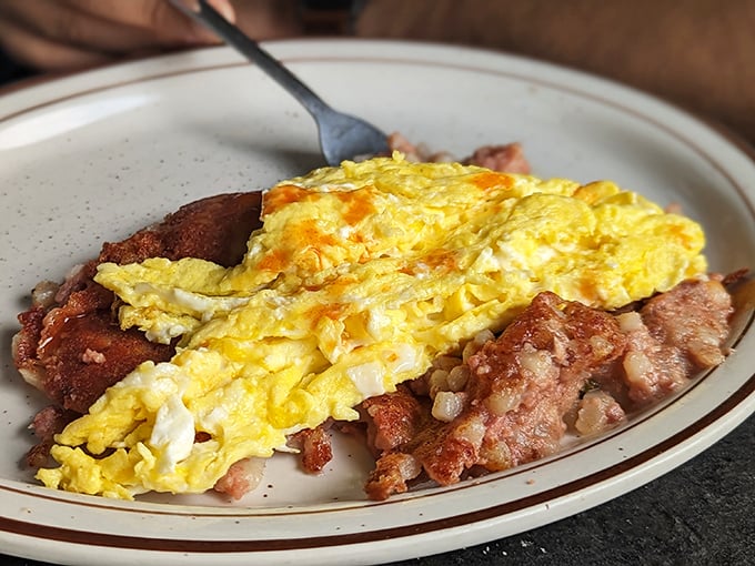 Breakfast alchemy at its finest: eggs that practically glow, perfectly crisped potatoes, and meat cooked with the reverence it deserves.