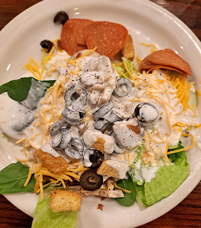 This isn't just any Caesar salad&mdash;it's a masterpiece of creamy indulgence where olives, cheese, and pepperoni conspire to make you forget you're technically eating vegetables.