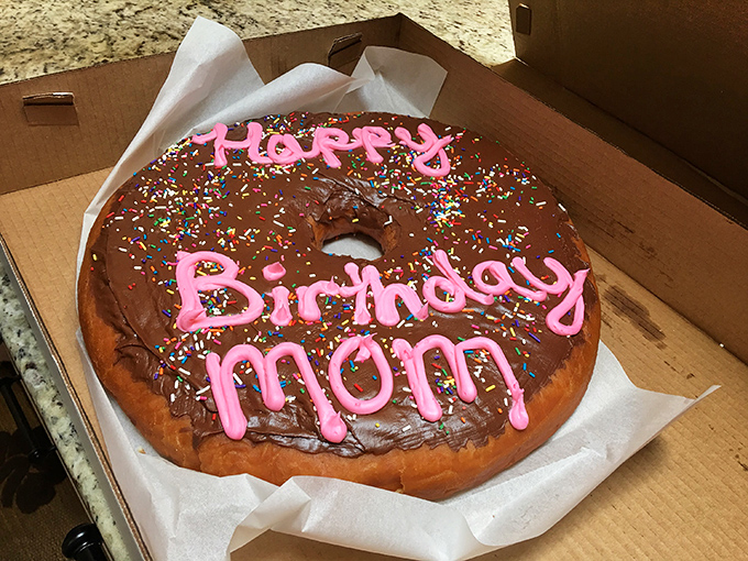 Someone's mom is having the birthday celebration she deserves&mdash;a giant chocolate-frosted donut that puts candles and cake to shame.