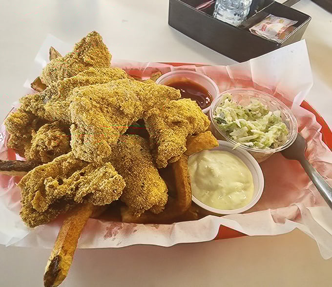 Golden-fried catfish nuggets that crunch like nature's perfect potato chip, with sides of slaw and sauce that deserve their own fan club.
