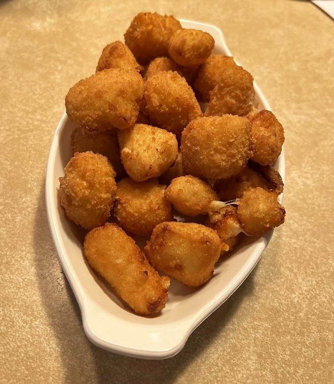 Golden nuggets of dairy perfection that squeak when you bite them—Wisconsin's cheese curds aren't just food, they're a religious experience.