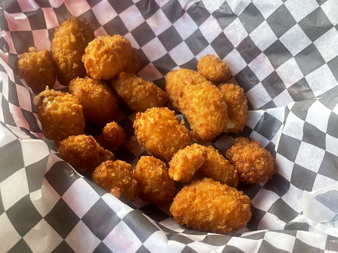 These golden nuggets of joy aren't just cheese curds; they're little breaded miracles that make you wonder why you'd ever waste stomach space on lesser appetizers.