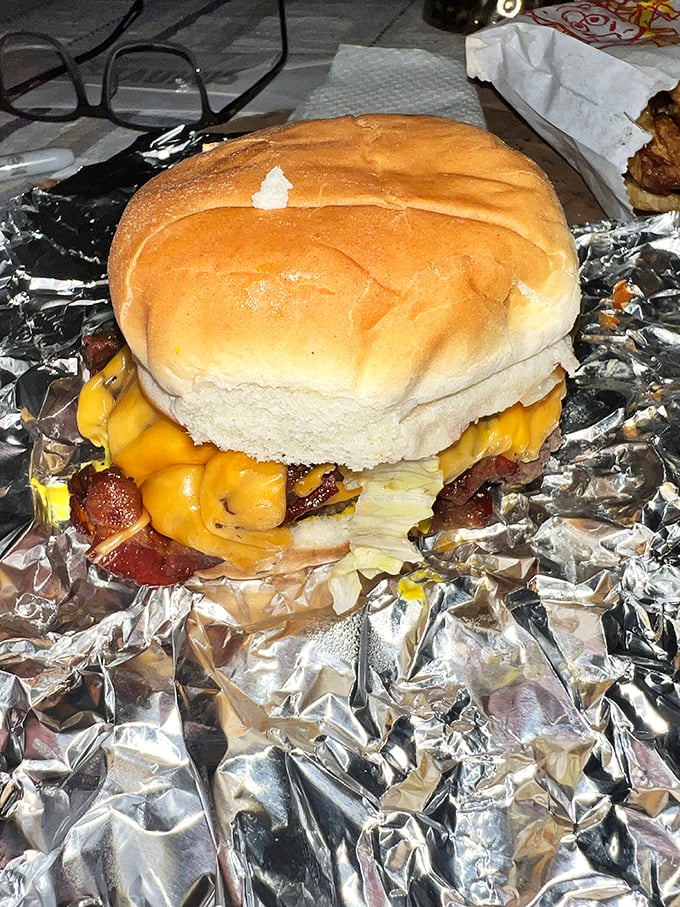 This isn't just a cheeseburger; it's a masterpiece wrapped in foil. The melted cheese cascades over the patty like a yellow waterfall of happiness.