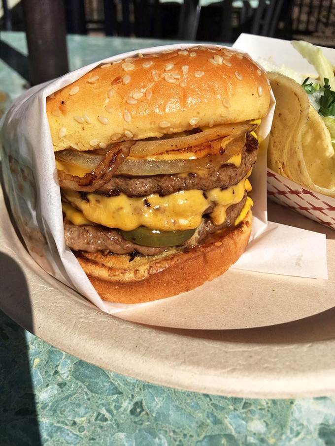 Behold the double cheeseburger in its natural habitat&mdash;melty American cheese cascading down perfectly grilled patties like a yellow waterfall.