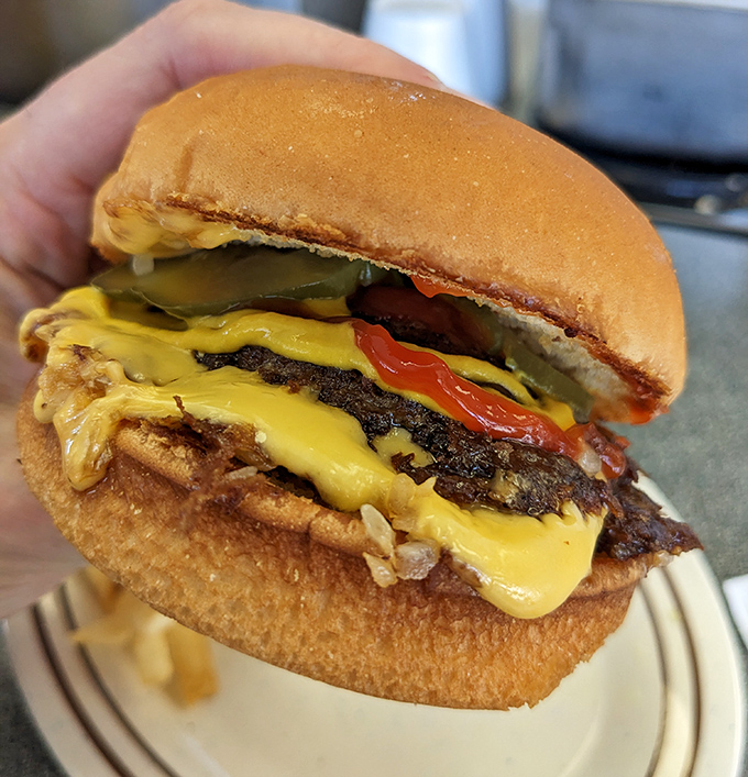 Not all heroes wear capes—some come wrapped in yellow cheese, nestled between perfectly toasted buns with that ideal meat-to-condiment ratio.