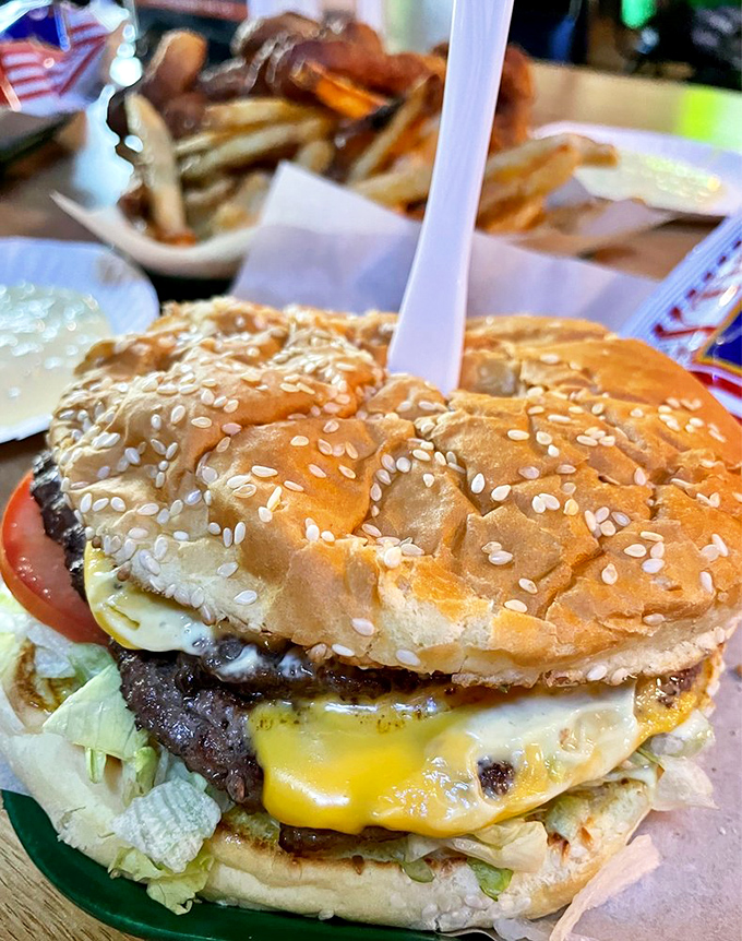 This isn't just a cheeseburger; it's a towering monument to American culinary ingenuity, complete with a sesame seed crown fit for burger royalty.