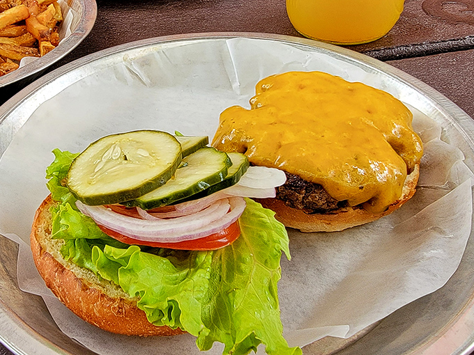 This isn't just a cheeseburger&mdash;it's a masterpiece of melty perfection atop a hand-formed patty, with fresh veggies standing by for that essential textural contrast.
