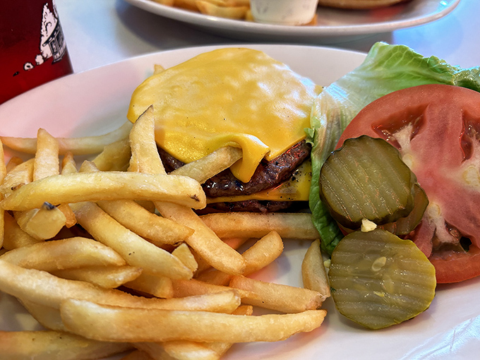 Behold, the star of the show&mdash;a perfectly melted cheese blanket draped over a charcoal-grilled patty. This isn't just a cheeseburger; it's Delaware's edible heritage.