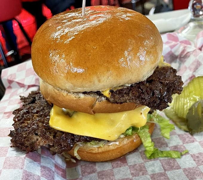 Behold the legendary cheeseburger with its signature crispy edges extending beyond the bun. That lacy, crunchy skirt is the burger equivalent of finding an extra $20 in your pocket.