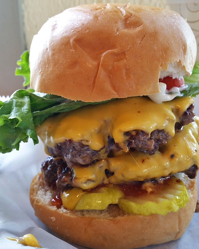 Architecture in its most delicious form. This towering achievement of beef, cheese, and fresh toppings makes skyscrapers seem unambitious by comparison.