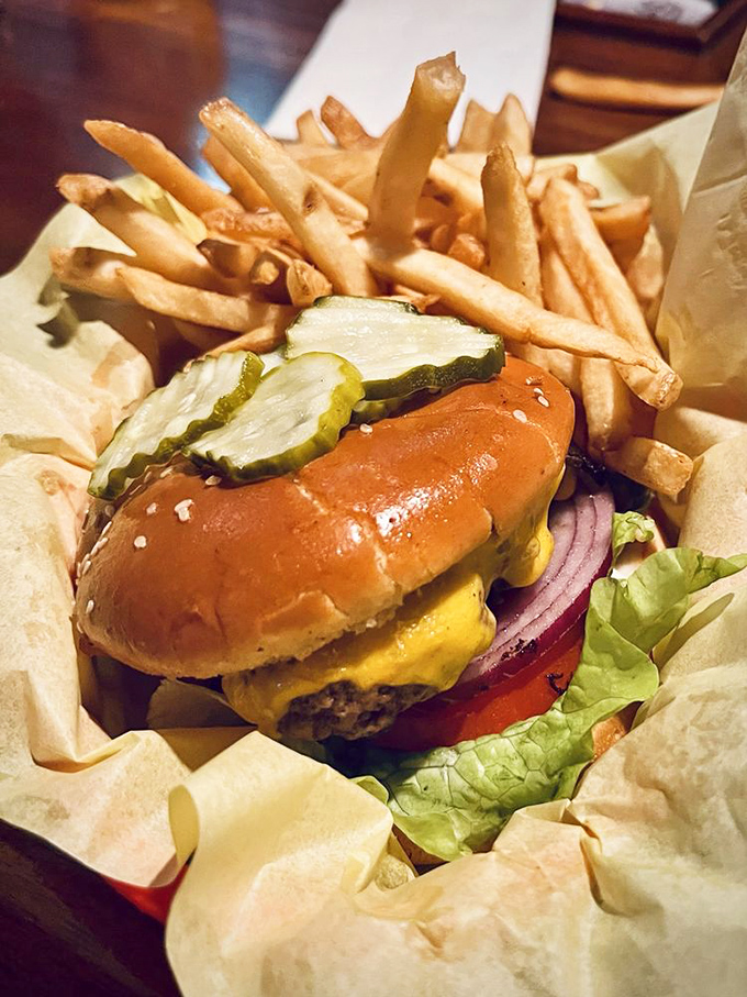 Behold the star of the show&mdash;a perfectly proportioned cheeseburger nestled among golden fries. That pickle isn't just garnish; it's essential counterpoint.