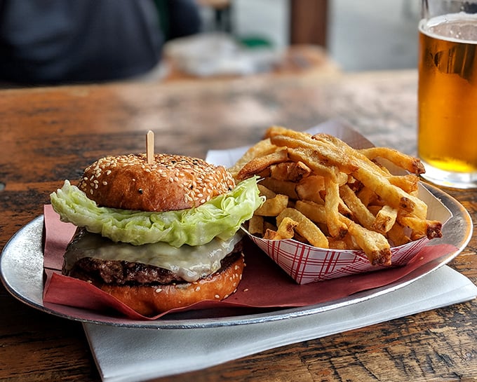 Behold the burger that launched a thousand food pilgrimages, accompanied by fries so perfectly golden they deserve their own Instagram account.