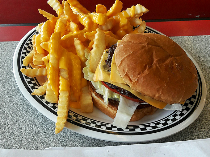 The star of the show arrives without fanfare—a perfectly griddled cheeseburger with golden fries that would make fast food chains weep with inadequacy.