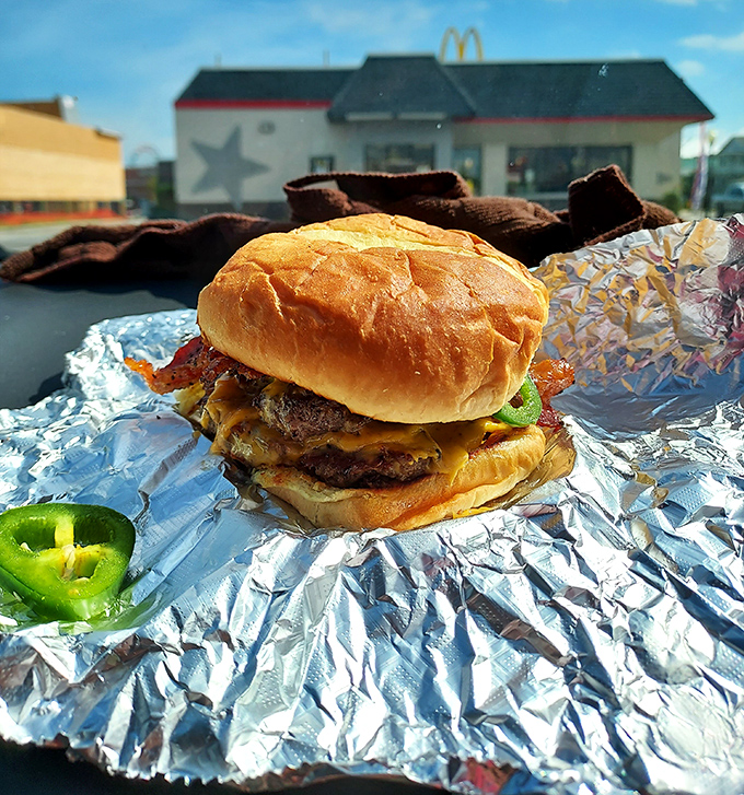 This isn't a burger, it's a structural engineering project wrapped in foil and sprinkled with pure happiness.