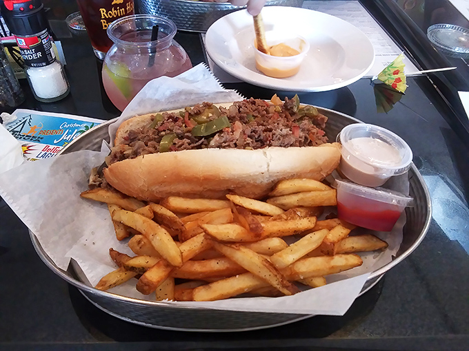Behold the cheesesteak that's converting skeptics into believers &ndash; perfectly proportioned with golden fries as loyal sidekicks.