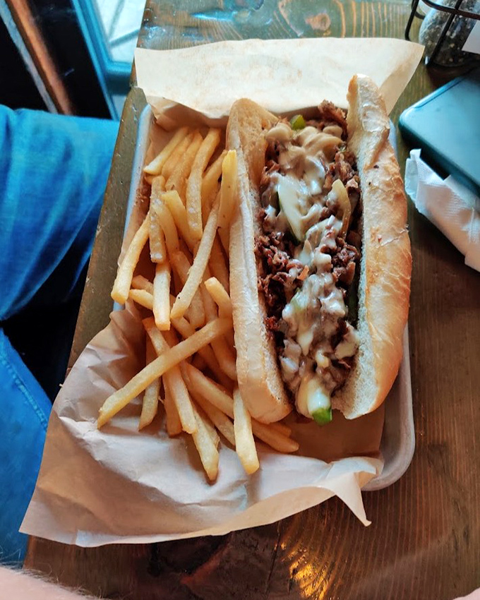 Behold the star of the show: a perfect cheesesteak where thinly sliced ribeye meets melty cheese in a crusty-yet-soft roll that deserves its own fan club.
