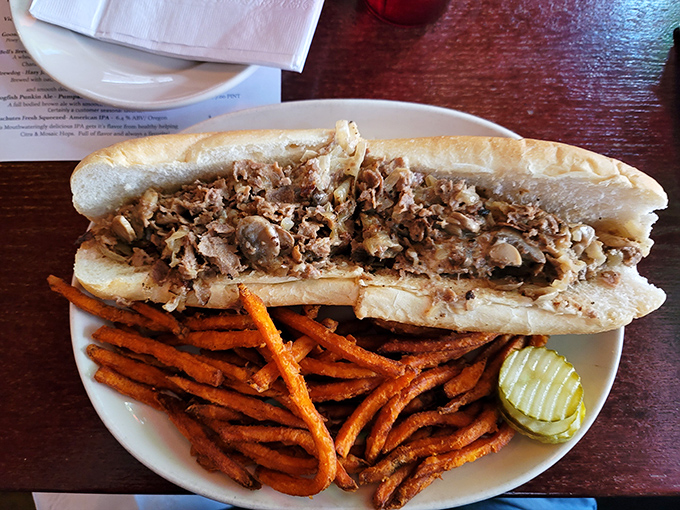 The cheesesteak that launched a thousand cravings, served with sweet potato fries that somehow make you feel virtuous about your choices.