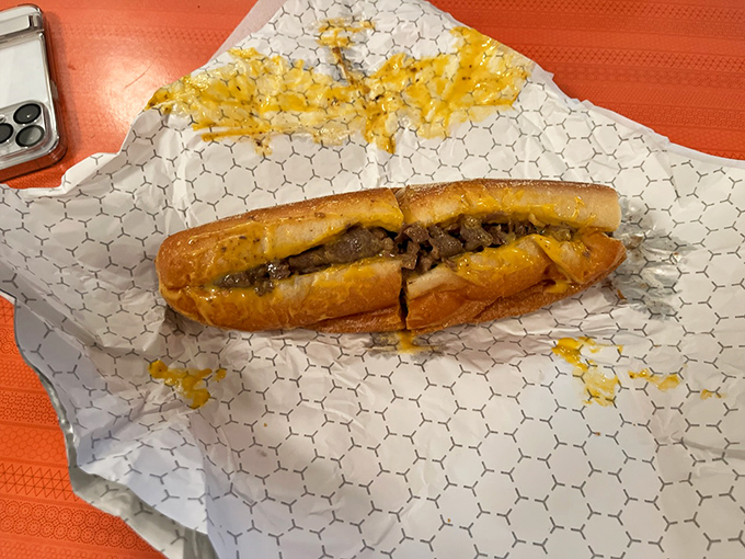 Behold the star of the show &ndash; a perfect Philly cheesesteak with golden cheese oozing over thinly sliced ribeye, nestled in that iconic Amoroso roll.