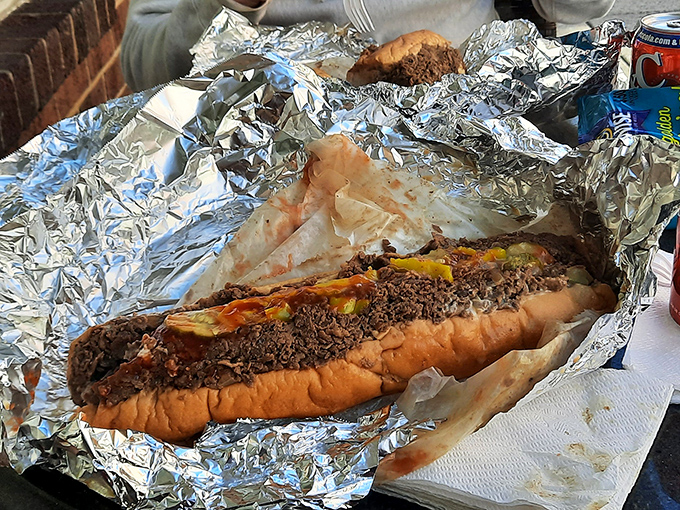 Behold the star attraction—a proper Philly cheesesteak wrapped in foil, not Instagram filters. That meat-to-cheese ratio is what dreams are made of.
