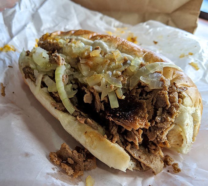 Behold the star of the show &ndash; thinly sliced ribeye and caramelized onions nestled in a perfect roll. This isn't just a sandwich; it's an Allentown institution on wax paper.