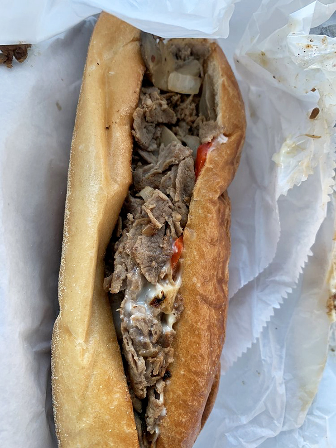 Behold the star of the show: thinly sliced beef, melted cheese, and a perfect roll. Poetry doesn't always need words.