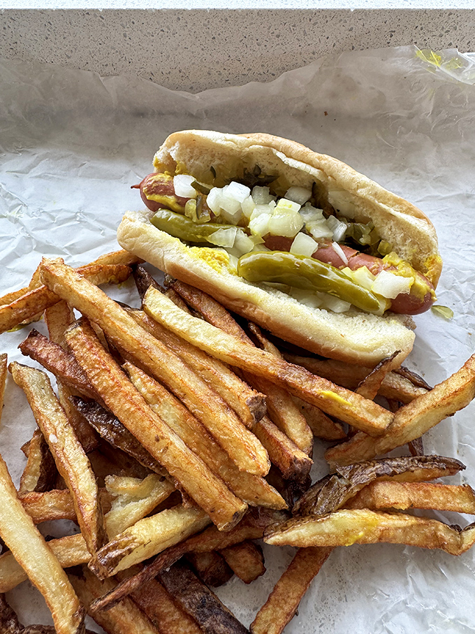 This isn't just a hot dog&mdash;it's Chicago heritage wrapped in paper. The fries aren't a side; they're part of the experience.