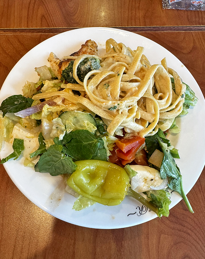 The legendary chicken Alfredo arrives like a creamy mountain of comfort, where tender chicken and al dente pasta swim in a sauce that should have its own fan club.